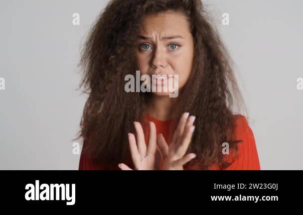 Emotional scared brunette girl standing alarmed and frightened watching ...