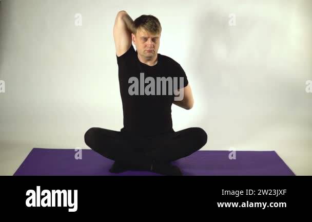 Lock behind his back, stretching in fitness on a white background a man ...