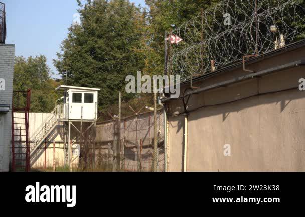 Coils of Barbed Wire on Top of a Fence. Jail Cells. Prison Interior ...