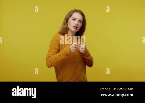 Female self-defense. Young slim woman with brown hair in pullover ...