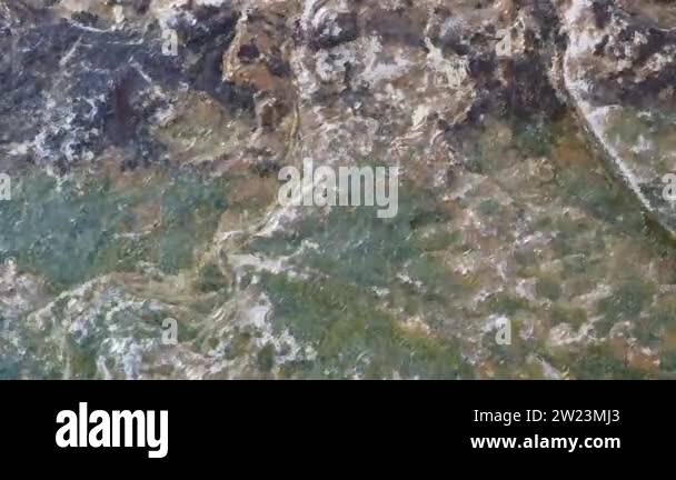 Rain drop heavy on mineral and hard granite stone surface of cave for ...