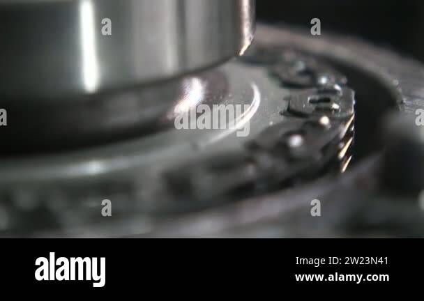 Shiny ball-bearing and large cogwheel rolling fast in a modern car ...