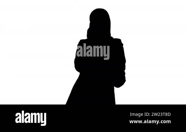 Silhouette Arabic Business woman wearing hijab speaking on the phone ...