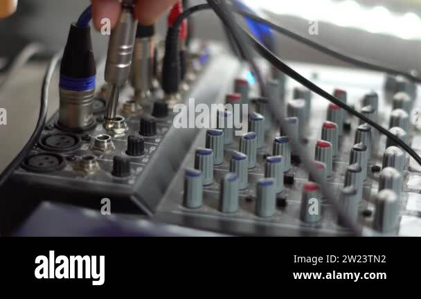 inserts wires into the mixing console Stock Video Footage - Alamy