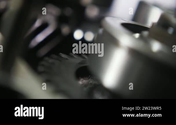 Sparkling ball-bearing and wide cogwheel rolling fast in a modern car ...