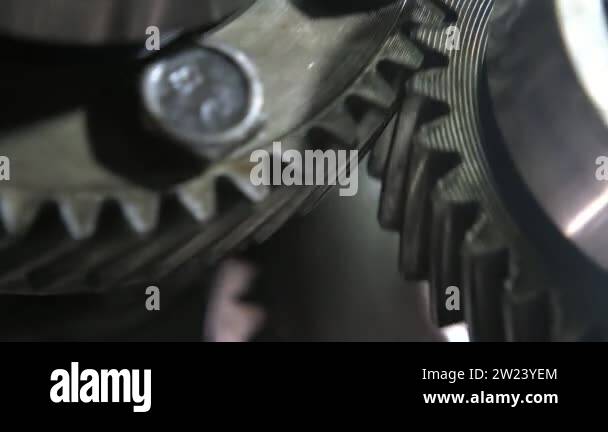 Revolting teeth of two wide cogs going askew in a contemporary auto ...