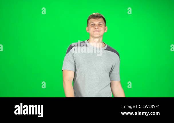 Guy goes and dances, smiles and rejoices on a green screen, Chroma Key ...