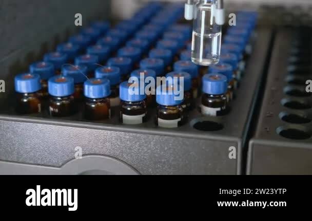 Auto sampler takes a vial and injects a sample into high performance liquid chromatography Stock ...