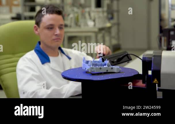 engineer scans high-quality plastic component with 3D scanner, rotating ...