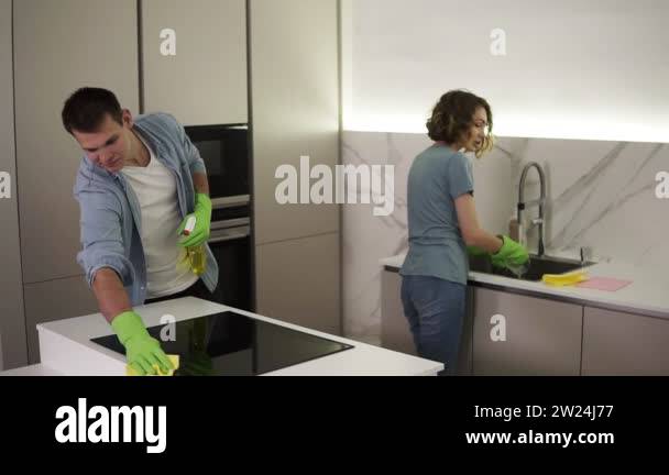 Young married couple in casual clothing and both in green gloves ...