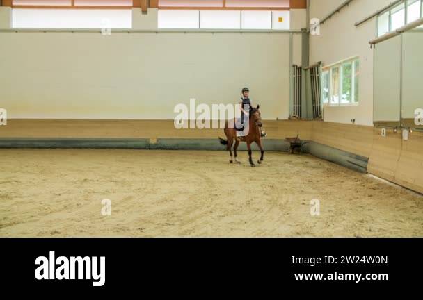 A Young Girl Is Having A Riding Session And She Is Practising One Of
