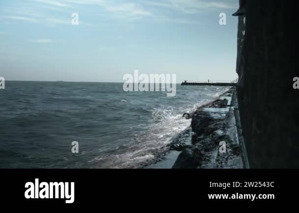 Tidal bore. Waves beat on the rocks. Waves are rolling on rocks. Sea ...