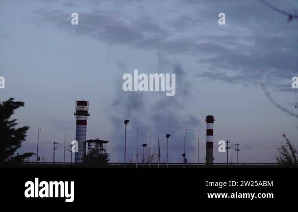 Emission of toxic gases smoke and fumes from tall chimneys of a factory ...