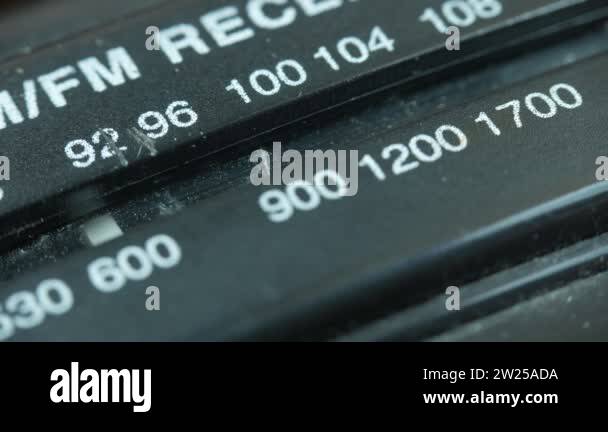 Tuning Analog Radio Dial Frequency on Scale of the Vintage Receiver. The frequency label moves ...