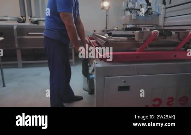 White man working. The process of making wallpaper, applying paint to a ...