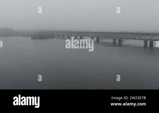 A barge loaded with scrap metal and waste floating on a water surface ...