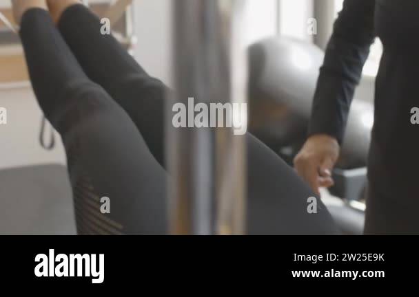 Camera moves from feet to head of sportswoman exercising on pilates ...