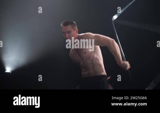 circus male muscular performer making tricks with juggling cube props ...