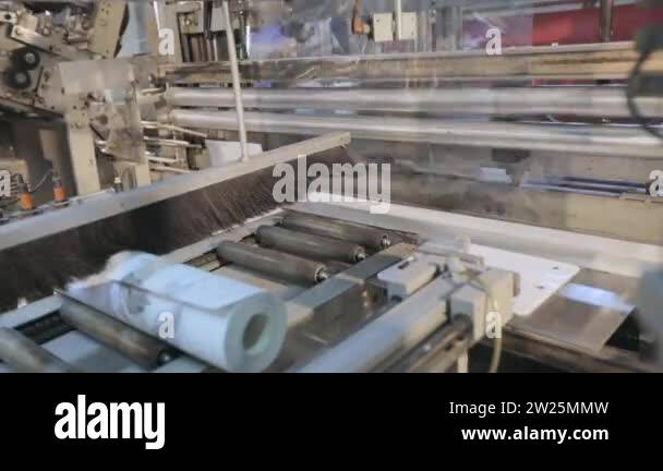 A roll of wallpaper on a conveyor line. Roll of wallpaper. Conveyor ...