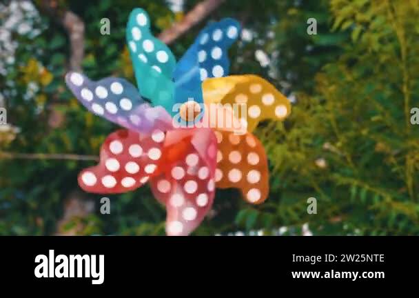 toy turbine rotate in wind blowing with green nature background Stock ...