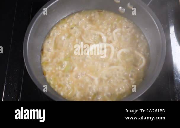 Close-up shot of bubbling boiling ingredients while cooking seafood ...