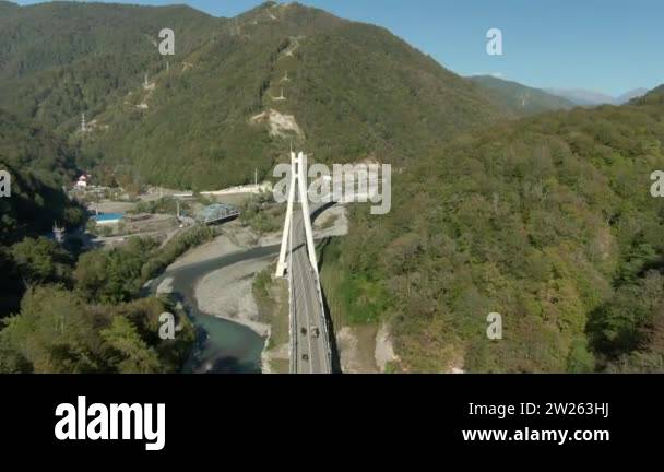 Flying over a high-speed highway in a mountain gorge above a stormy ...