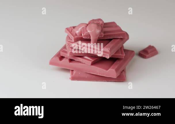 Melted ruby chocolate pouring into a piece of chocolate bars Stock ...