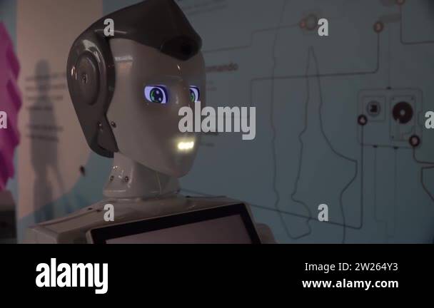 The robot shows emotions. Artificial Intelligence. Modern robotics. The robot looks and smiles ...