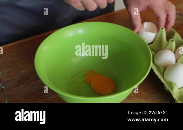 close-up of the hand, the cook, using a whisk from the mixer, breaks 4 ...