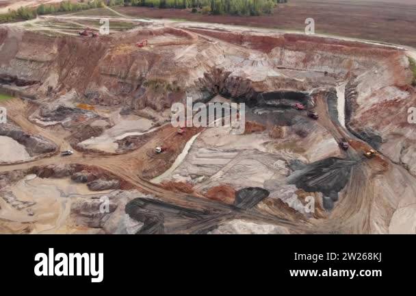Huge industrial clay mining quarry. Trucks are transporting loaded clay ...