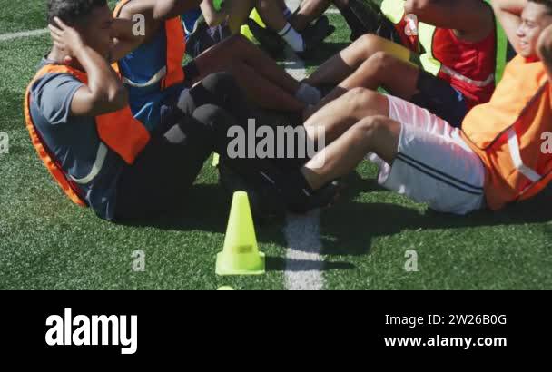 Side view of a multi-ethnic group of male football players wearing ...