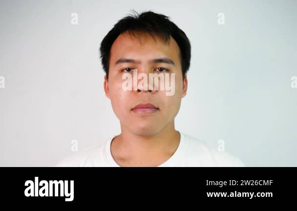 Close up portrait of Serious Asian man closing eyes and rubs his head ...