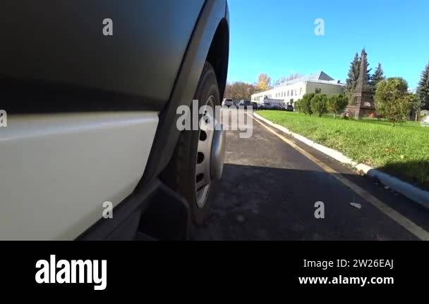 white van, moving, industrial area, clear sun shines, car turns ...