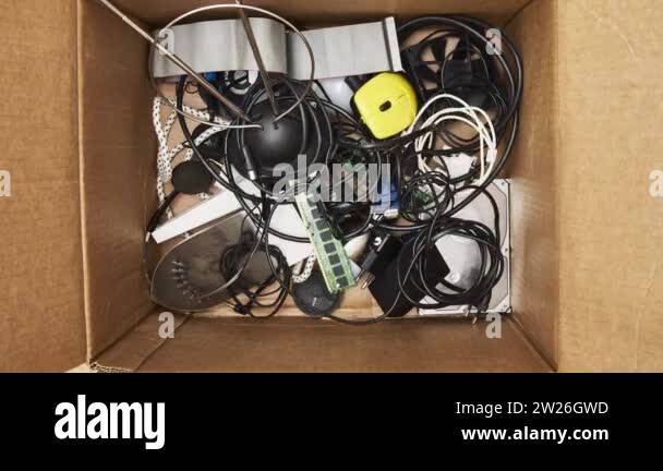Modern electronic waste in a cardboard box. HDD, power supply, speaker ...