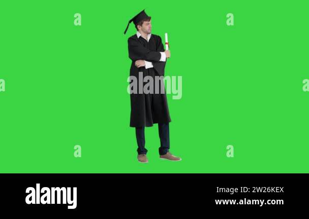 Man in graduation gown posing for the camera on a Green Screen, Chroma ...