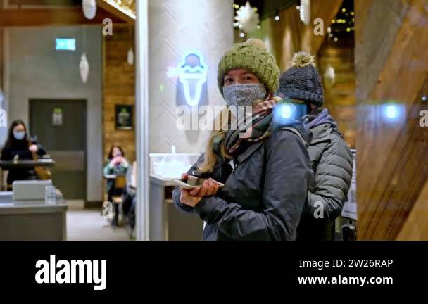 LONDON - NOVEMBER 3, 2020: Two women wear face masks while waiting for ...