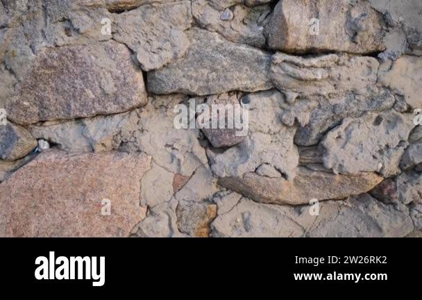 Texture of old stones of various forms with seams. Close up of shabby ...