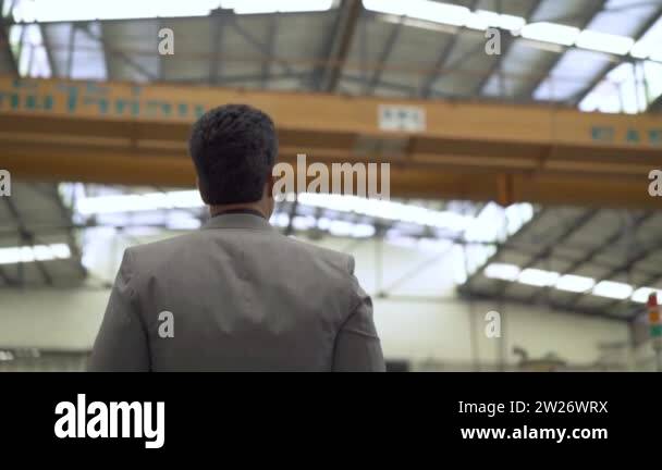 Young 20s Indian Asian factory business owner in formal suit walking ...
