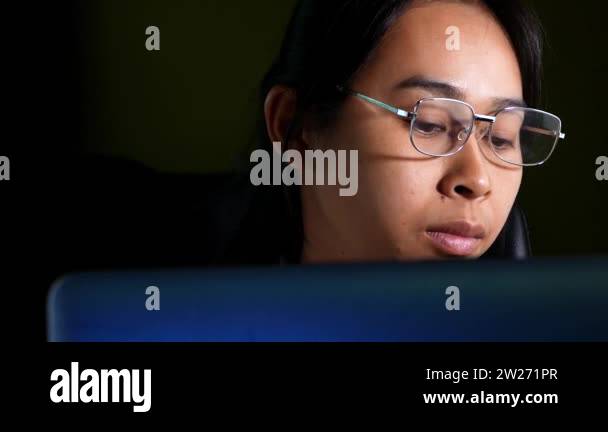 Unhealthy woman wearing glasses using laptop computer technology and ...