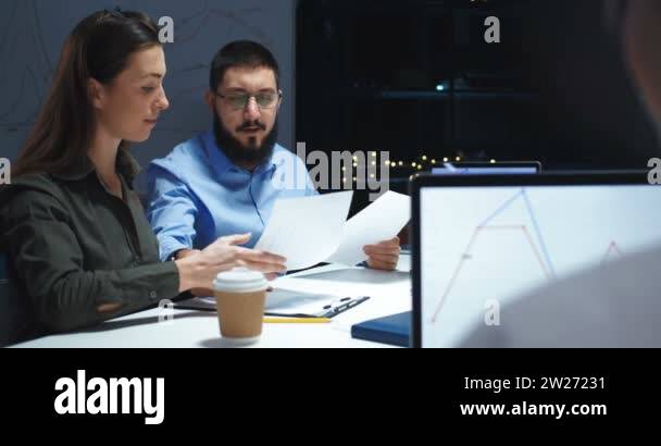 Caucasian young busy couple of office workers talking and working with ...