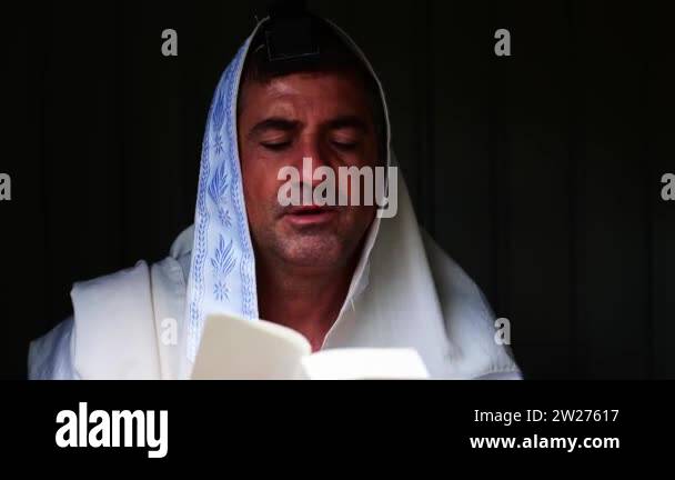 Adult Jewish man praying with with Tallit (prayer shawl) and Tefillin ...