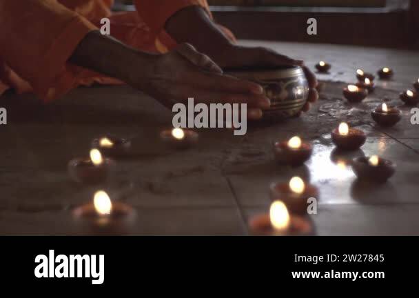 A monk in an ancient temple lights a sacred fire, the priestess brought ...