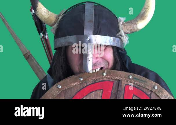 Aggressive viking warrior scares enemies by biting with crooked teeth ...