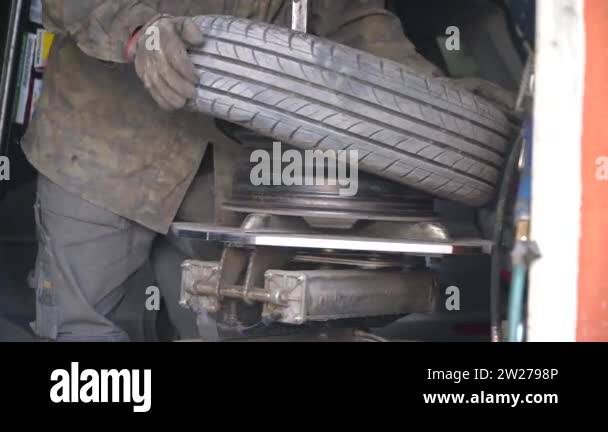 Repair flat tire from car by mechanic. Process of removing a tire from ...