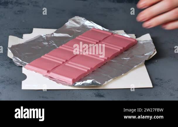 Breaking Ruby chocolate bar on pieces. New dimension of chocolate ...