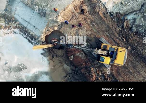 Metal beam is getting installed at the quarry site by the excavator ...