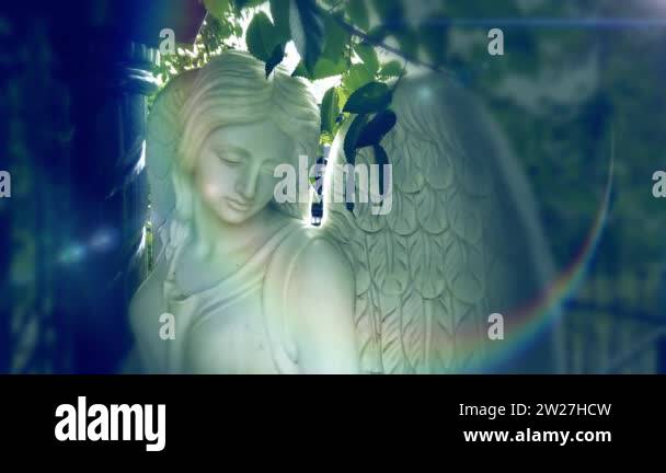 Figure of a praying angel. A very ancient stone statue. . Sad angel as ...