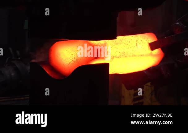 Hot iron under a huge press. Metal forging, stamping under hammer forge ...