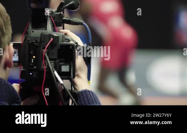 Cameraman with a camera in wrestling competitions. Close-up Stock Video ...