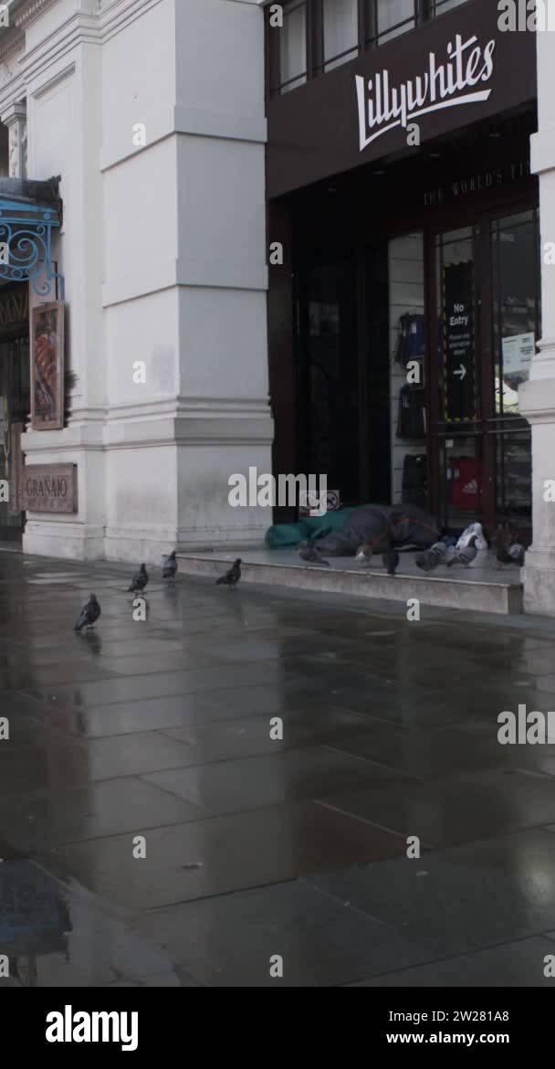 Two Homeless People Sleeping Under Store Front In Central London During ...